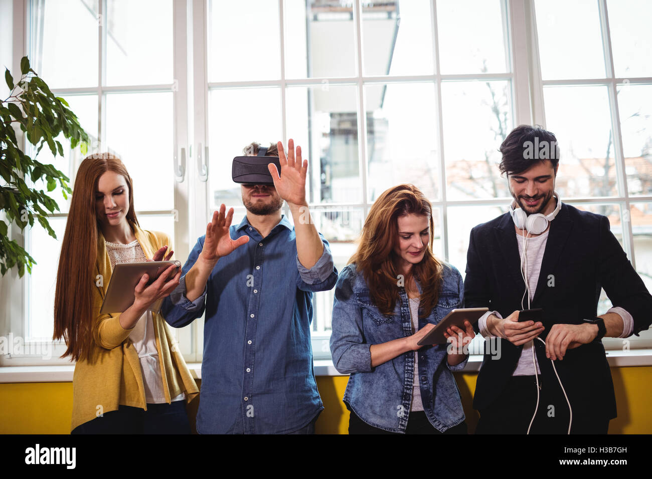 Stylish business people using electronic devices Stock Photo - Alamy