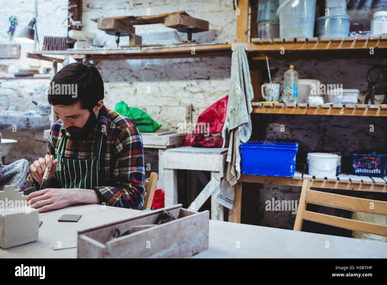 Focused man working at workshop Stock Photo - Alamy