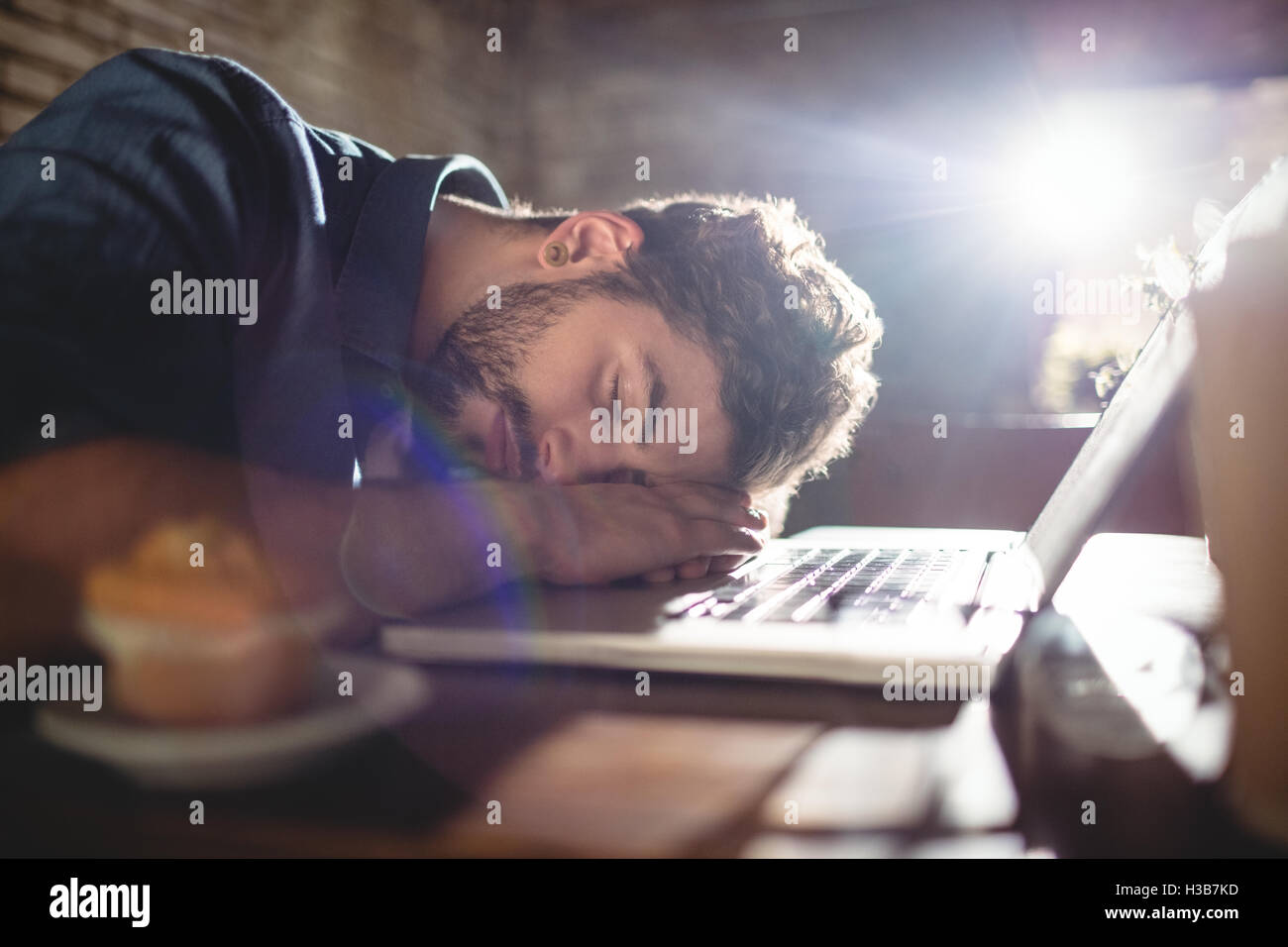 Tired customer sleeping at cafe Stock Photo - Alamy