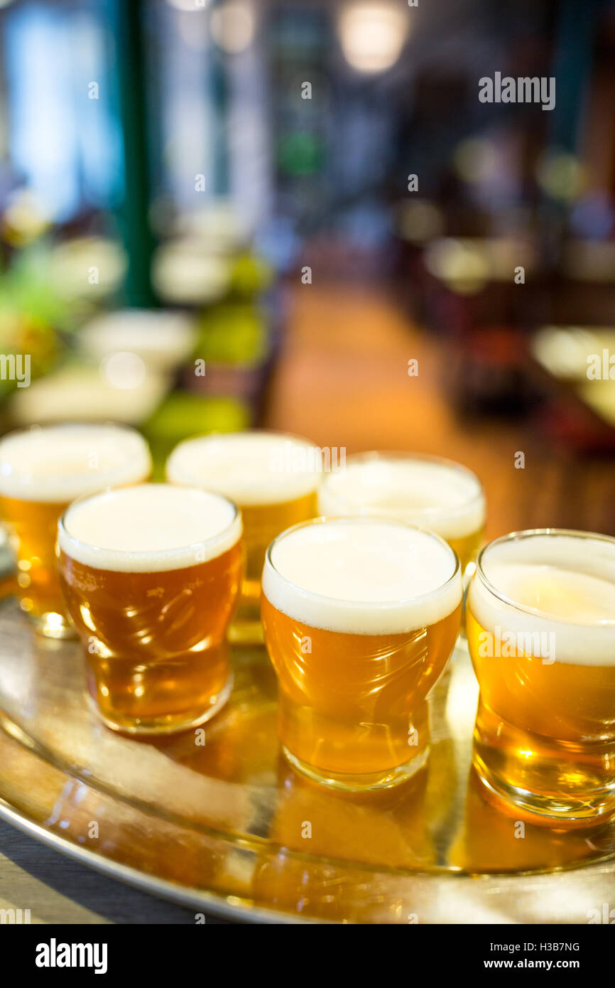 Close-up of beer glasses arranged in a tray on the counter Stock Photo ...