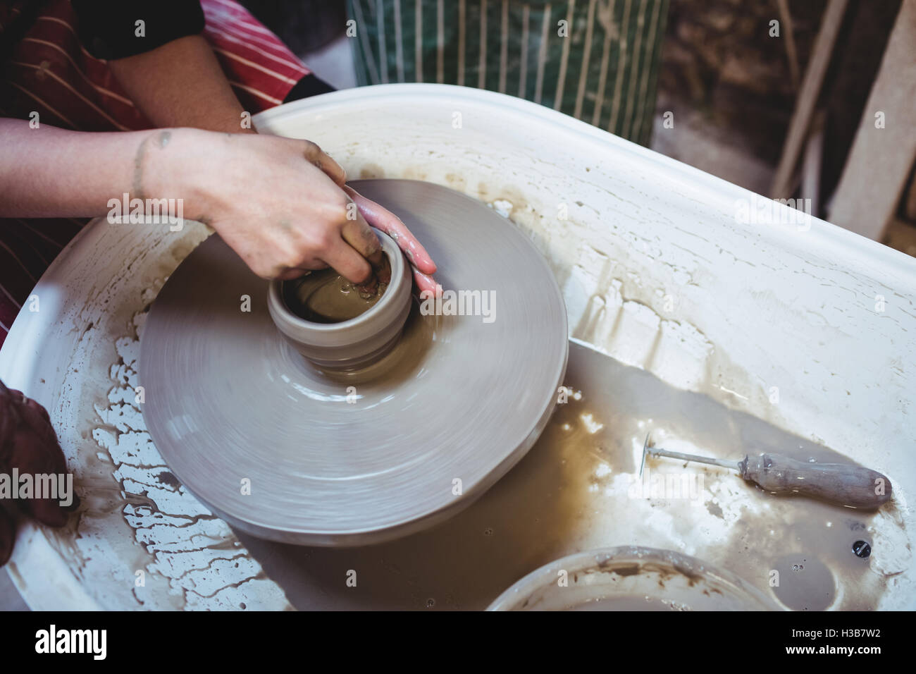 Cropped image of potter making pot Stock Photo - Alamy