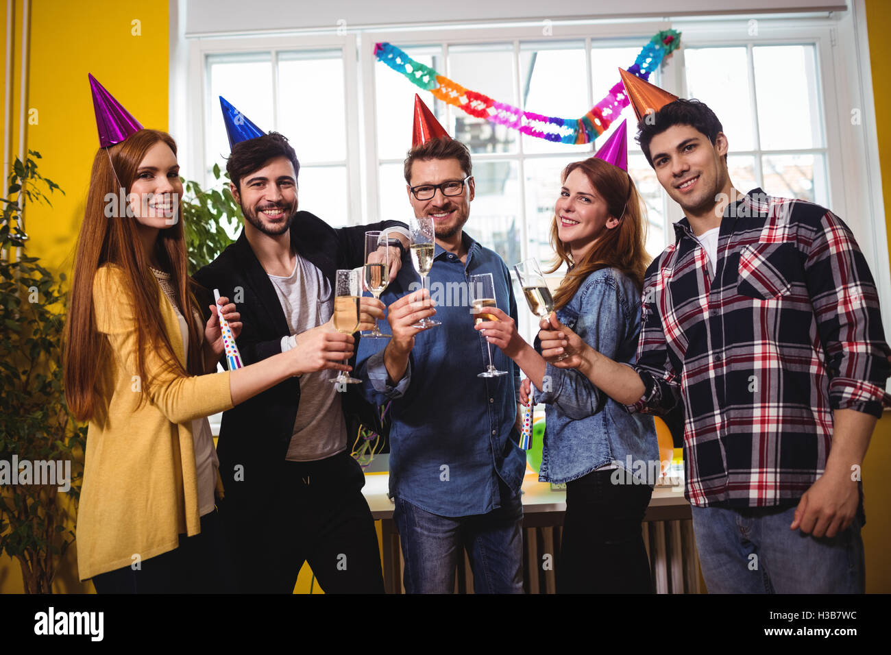 Business people having champagne during birthday party Stock Photo - Alamy