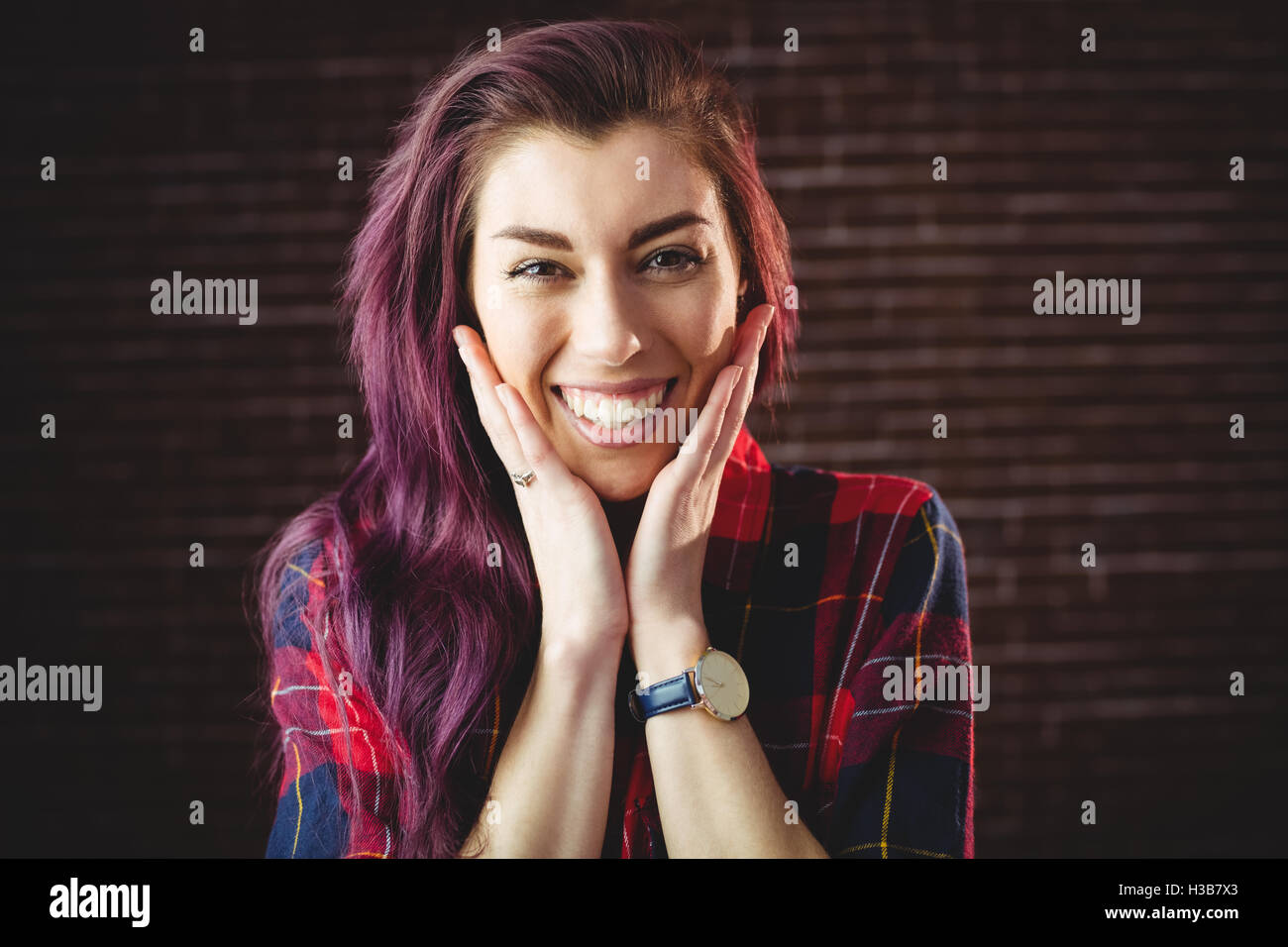 Young woman smiling at camera Stock Photo - Alamy
