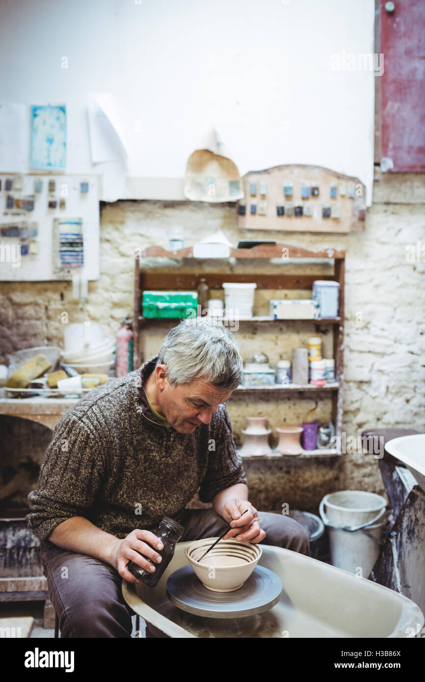 Mature man making pot Stock Photo - Alamy