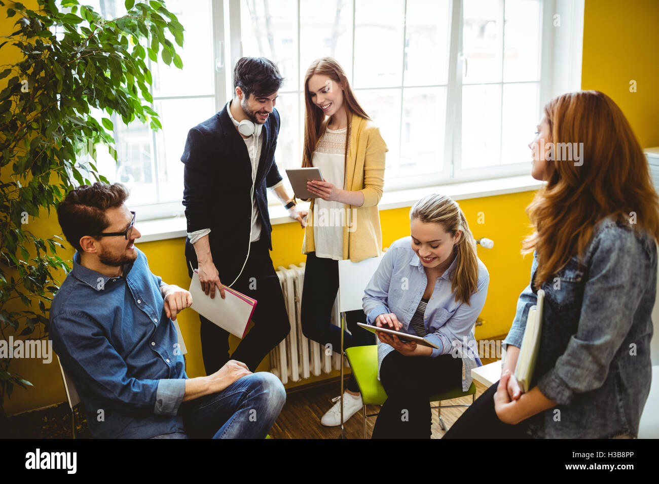 Happy creative business people using digital tablet Stock Photo - Alamy