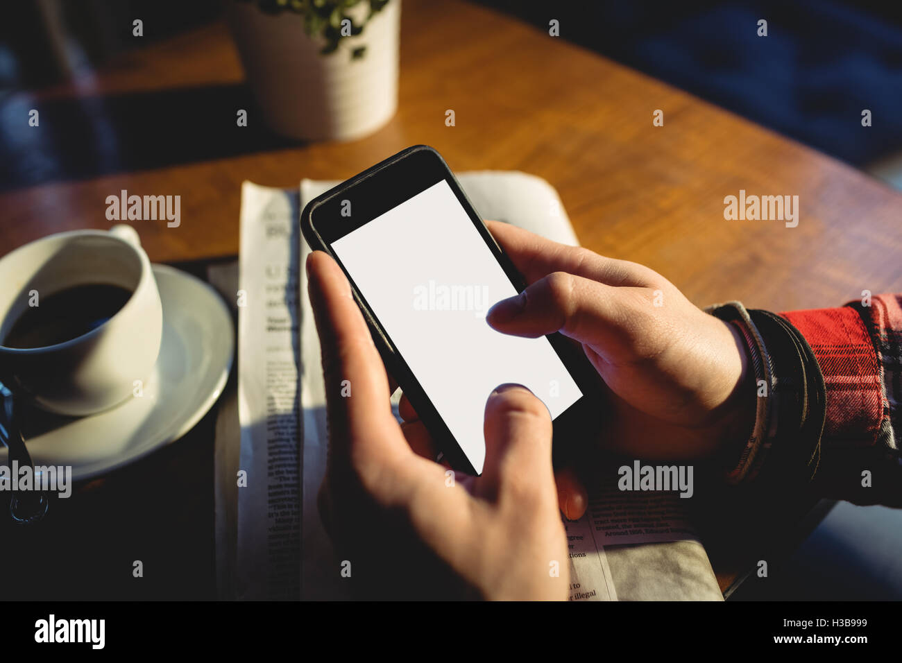 Cropped image of customer texting on cellphone at cafeteria Stock Photo ...