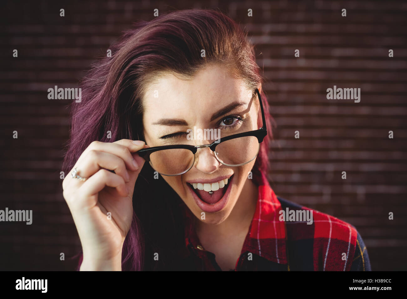 Young woman winking Stock Photo - Alamy