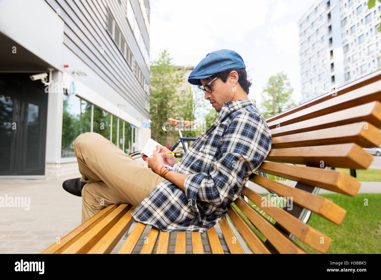 man with notebook or diary writing on city street Stock Photo - Alamy