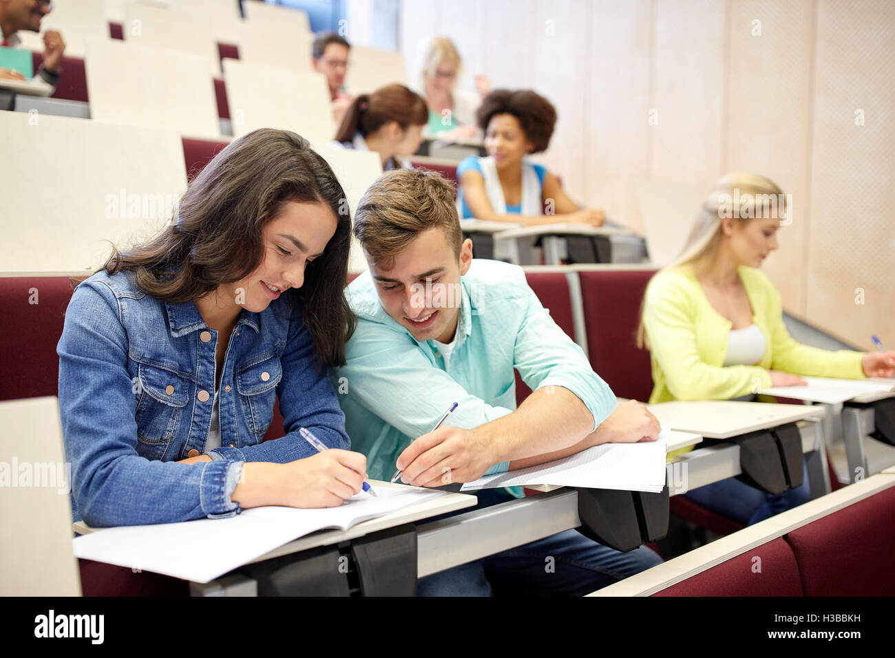 group of students with notebooks at lecture hall Stock Photo - Alamy