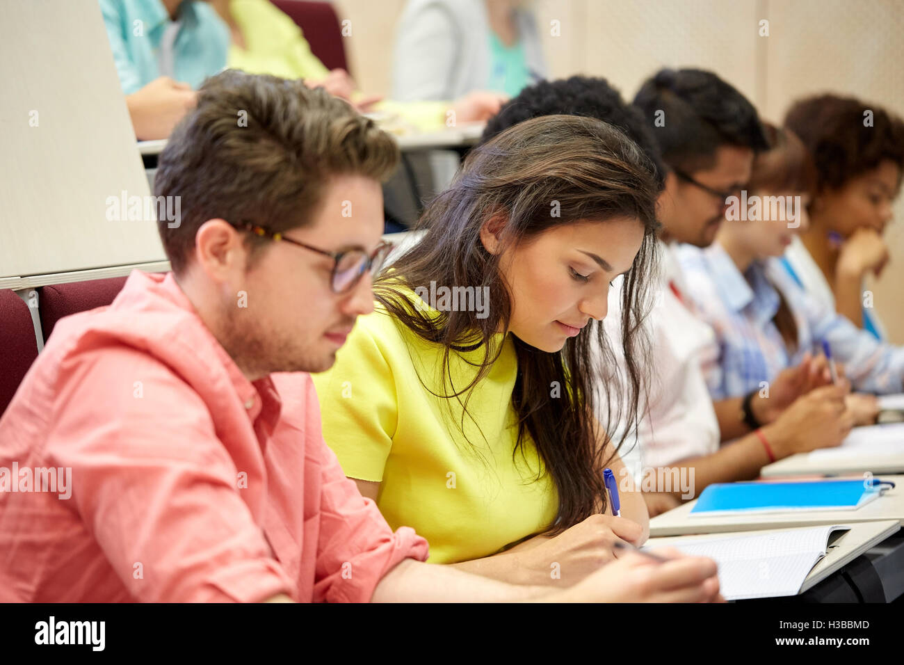 group of international students writing at lecture Stock Photo - Alamy