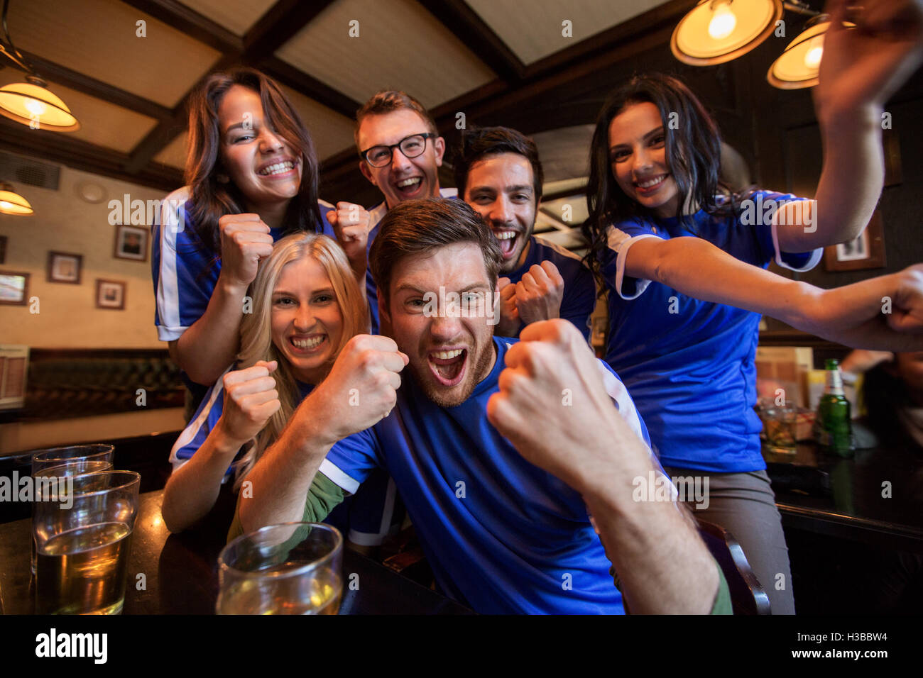 football fans or friends with beer at sport bar Stock Photo - Alamy