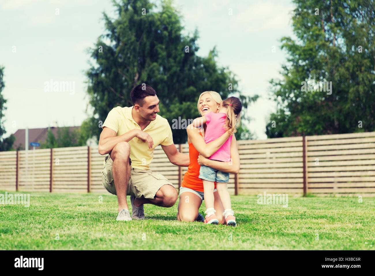 happy family hugging outdoors Stock Photo - Alamy