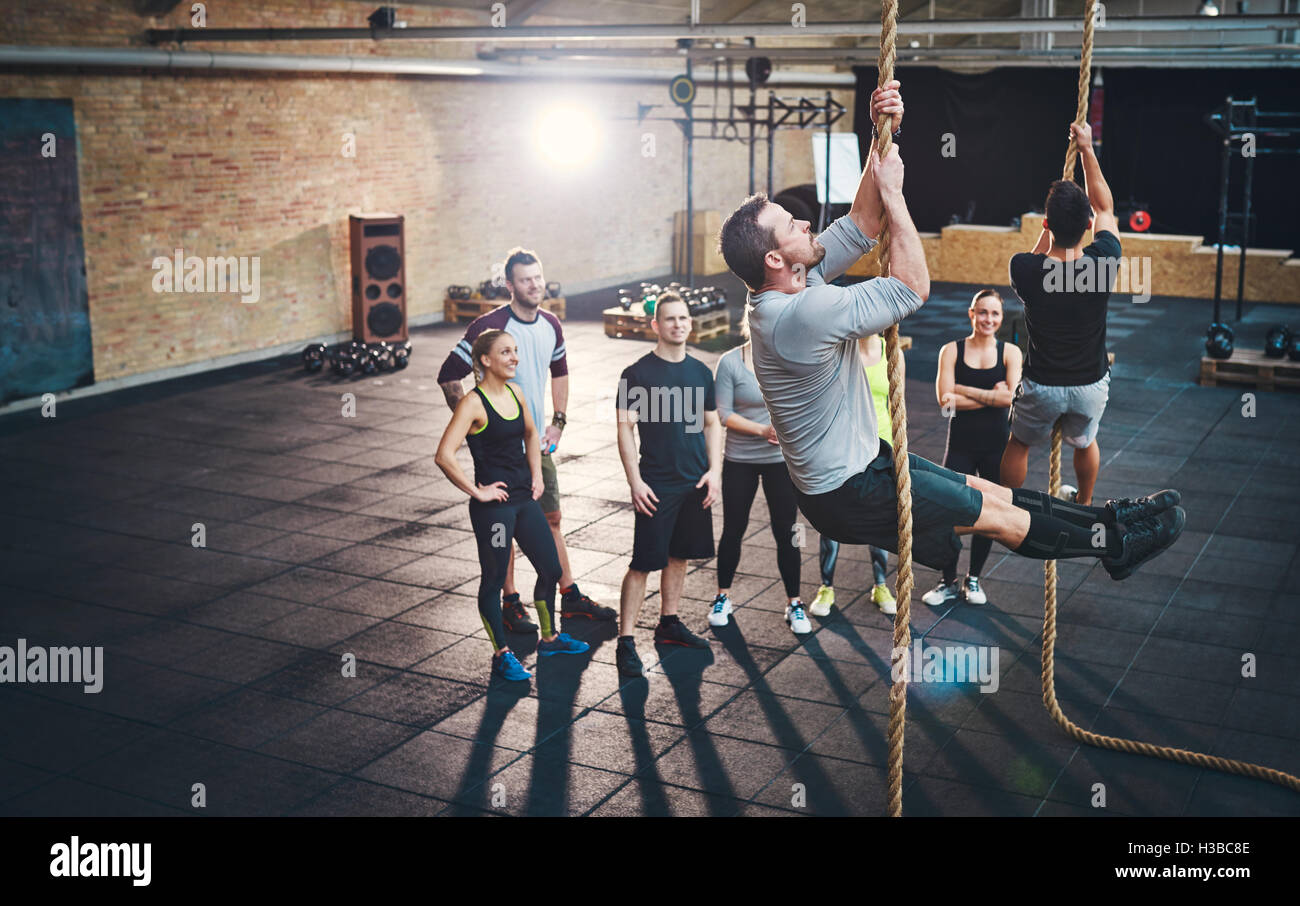 Climbing a rope in gym class hi-res stock photography and images - Alamy