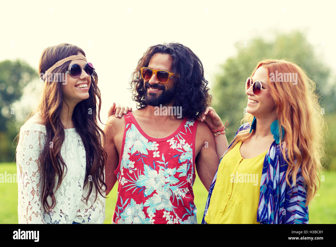 smiling young hippie friends talking outdoors Stock Photo - Alamy