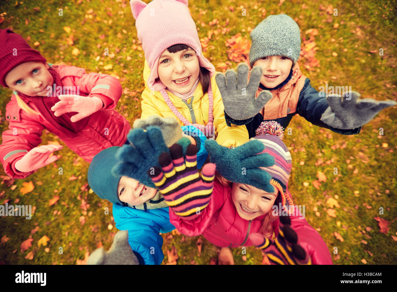 happy children waving hands in autumn park Stock Photo - Alamy