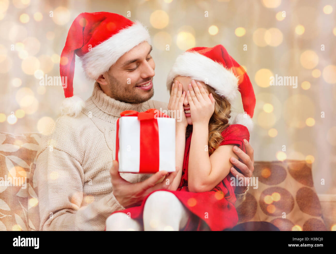 smiling daughter waiting for a present from father Stock Photo - Alamy