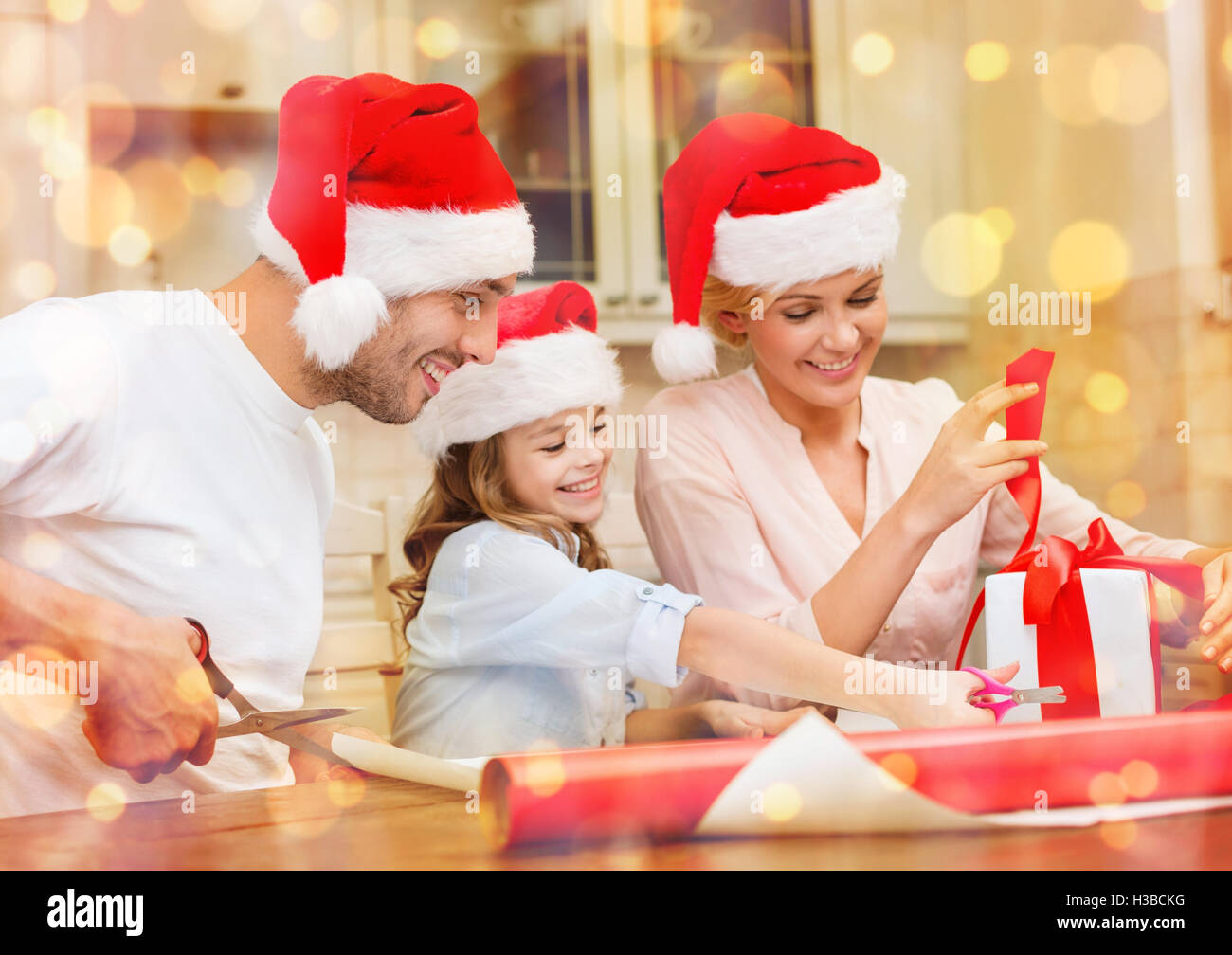 smiling family in santa helper hats with gift box Stock Photo - Alamy