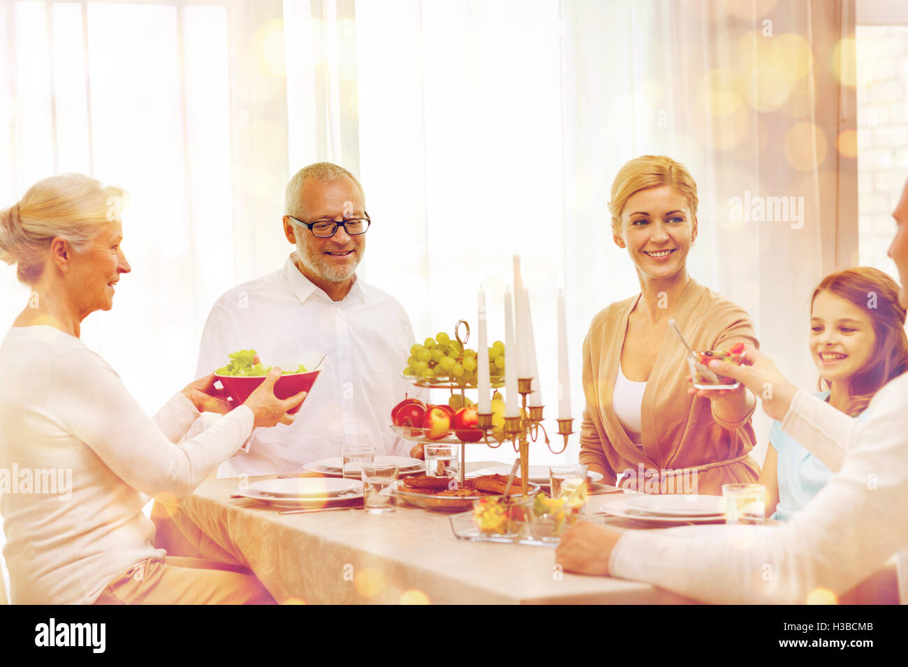 smiling family having holiday dinner at home Stock Photo - Alamy