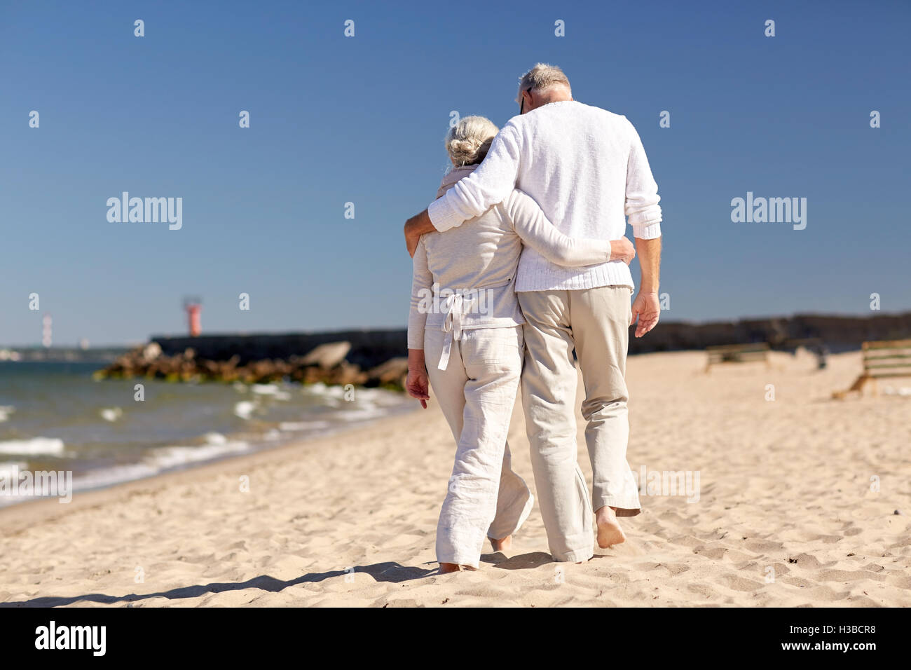 Mature couple hugging on beach hi-res stock photography and images - Alamy