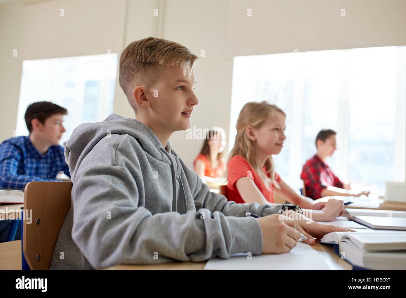 group of students with books at school lesson Stock Photo - Alamy
