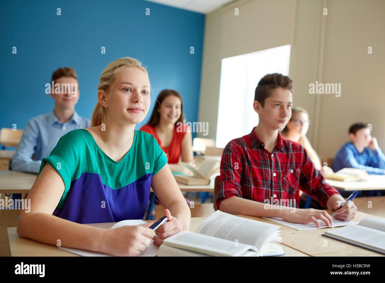 group of students with books at school lesson Stock Photo - Alamy