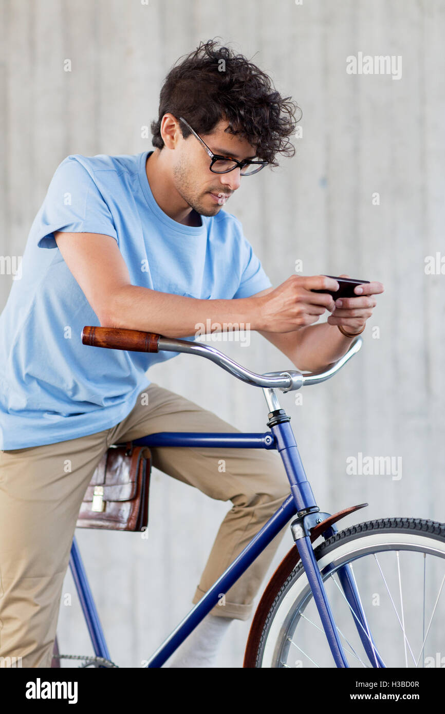 man with smartphone and fixed gear bike on street Stock Photo - Alamy