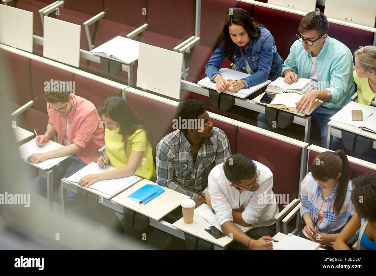 group of students with notebooks at lecture hall Stock Photo - Alamy