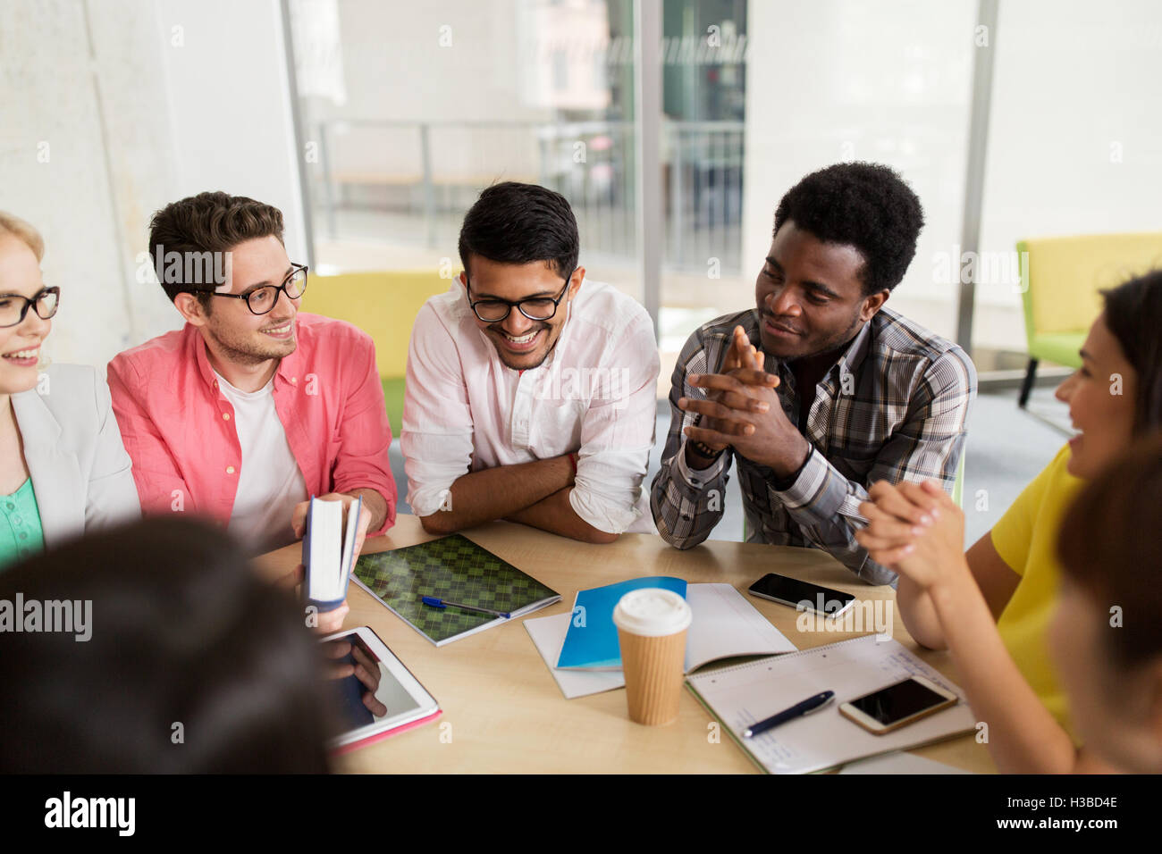 group of high school students sitting at table Stock Photo - Alamy