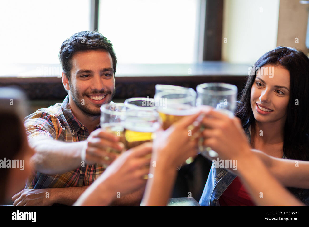 happy friends drinking beer at bar or pub Stock Photo - Alamy