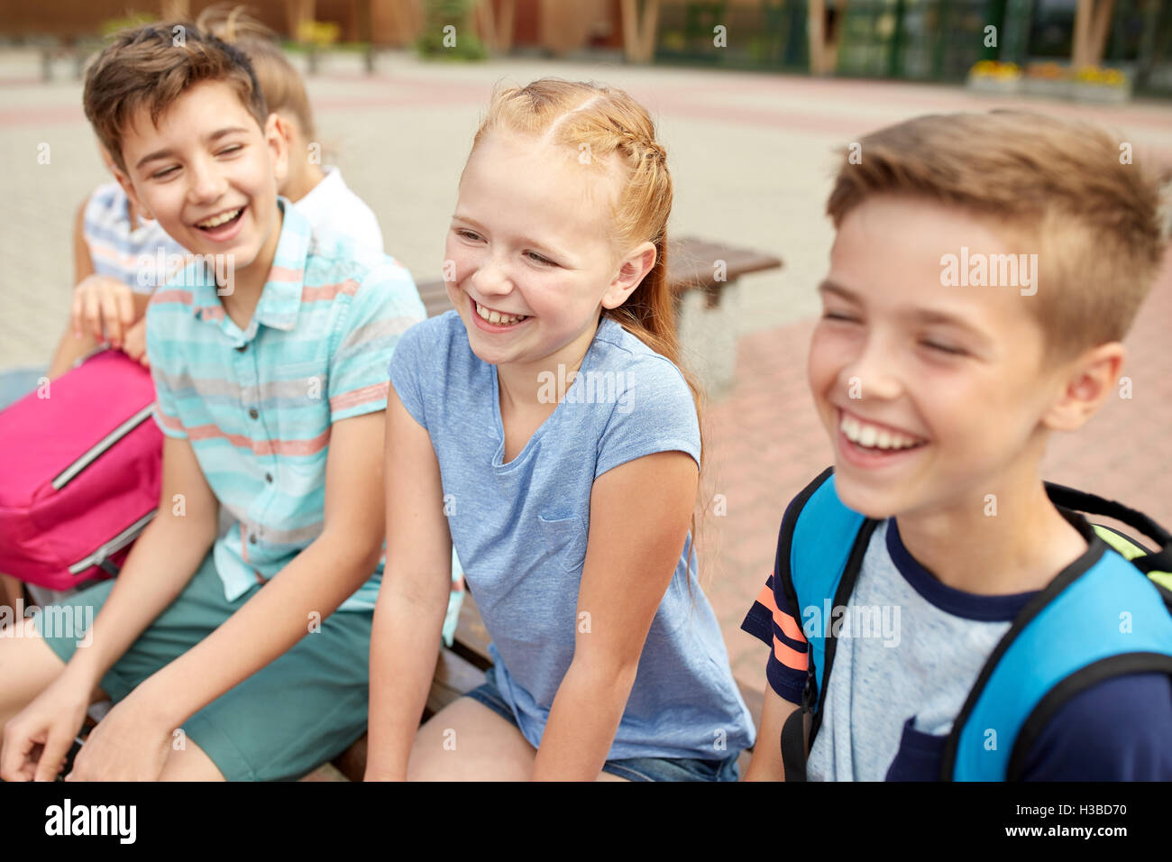 group of happy elementary school students talking Stock Photo - Alamy