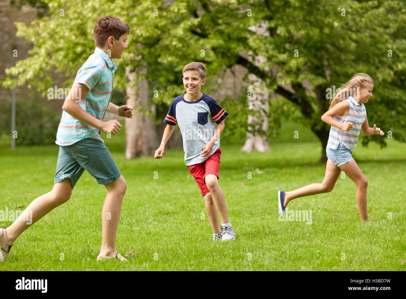 happy kids running and playing game outdoors Stock Photo - Alamy