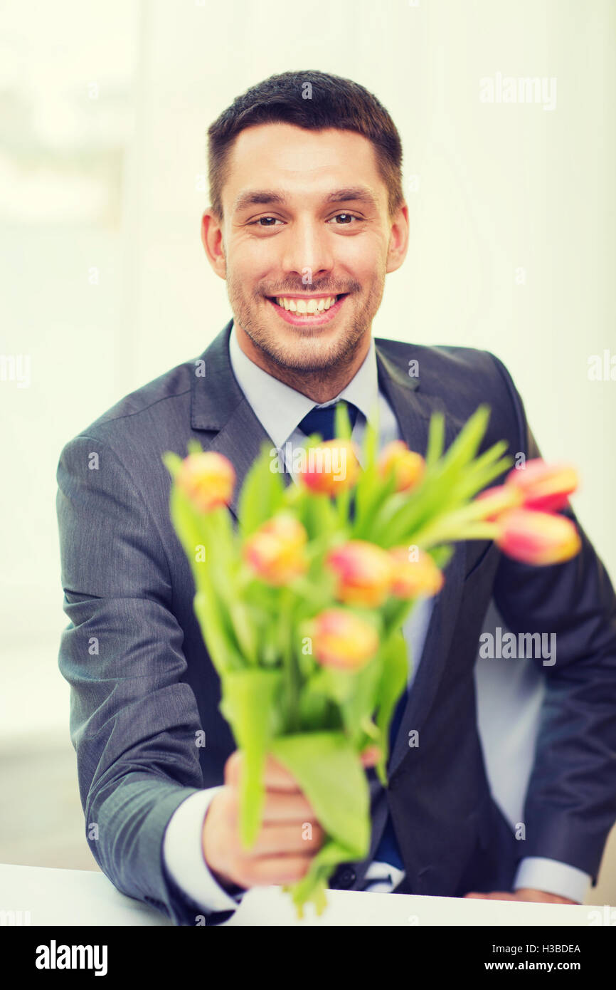 Handsome man giving bouquet flowers hi-res stock photography and images ...