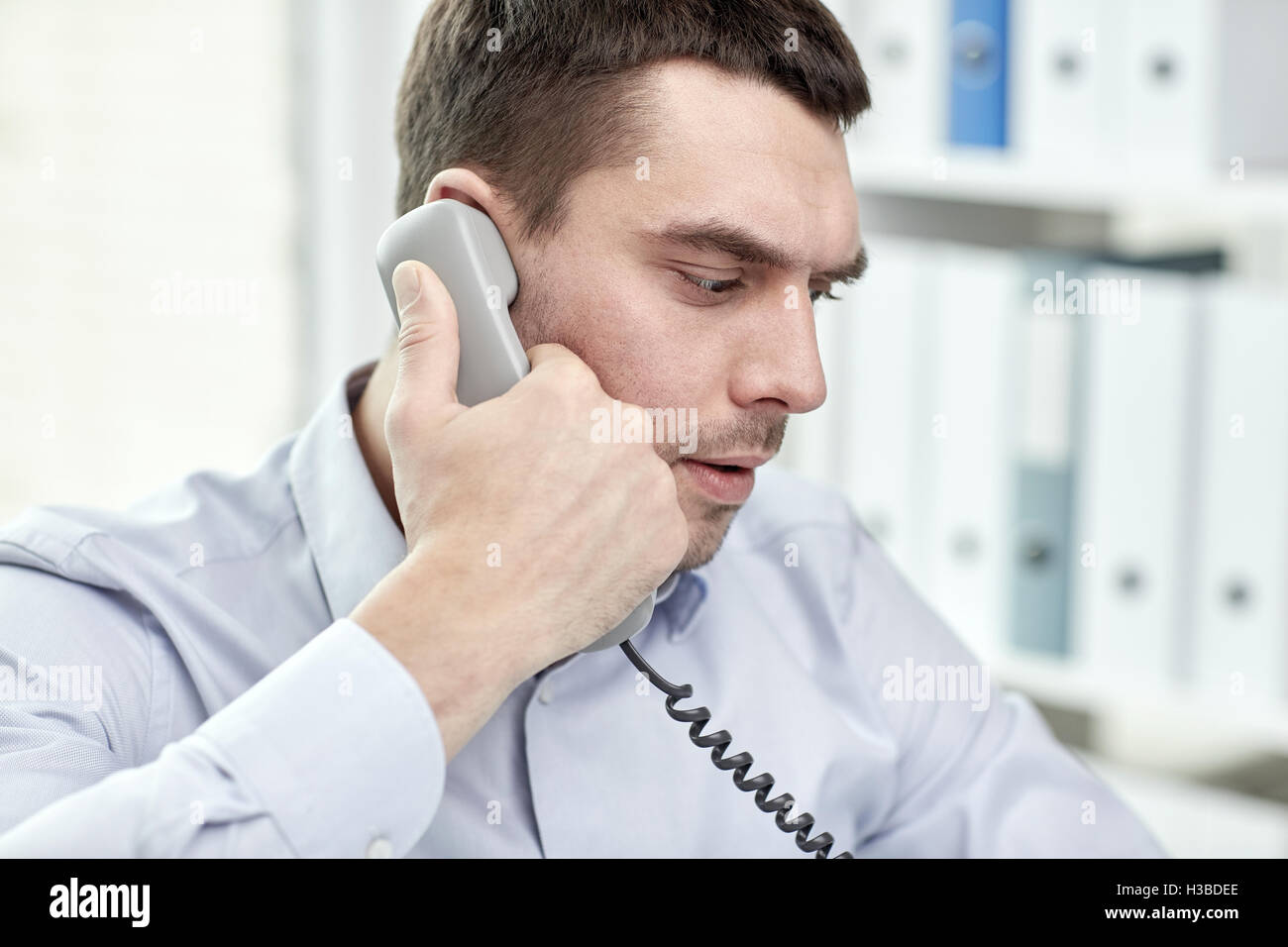 face of businessman calling on phone in office Stock Photo - Alamy
