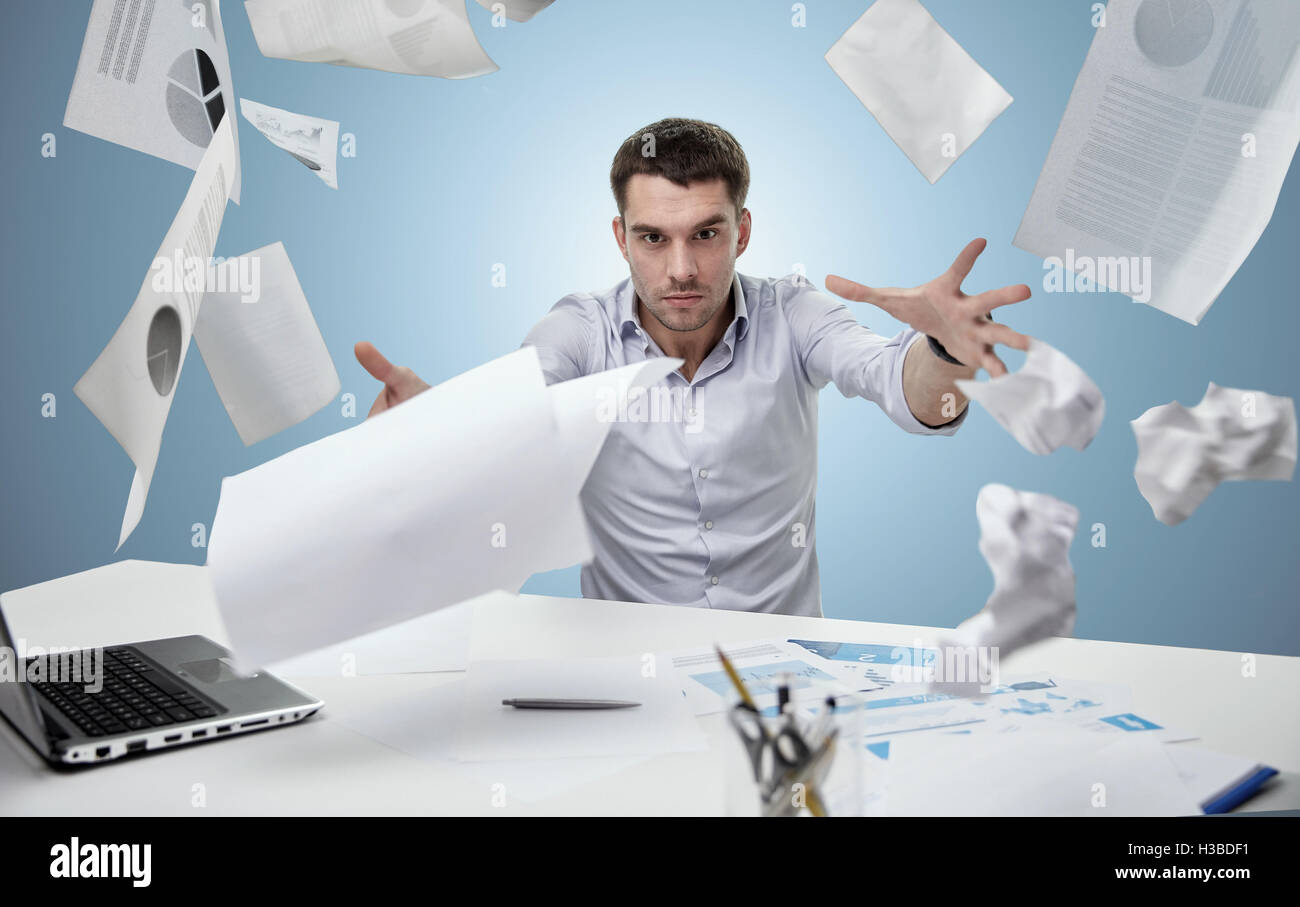angry businessman throwing papers in office Stock Photo - Alamy