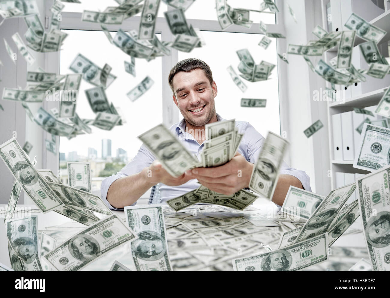 happy businessman with heap of money Stock Photo - Alamy