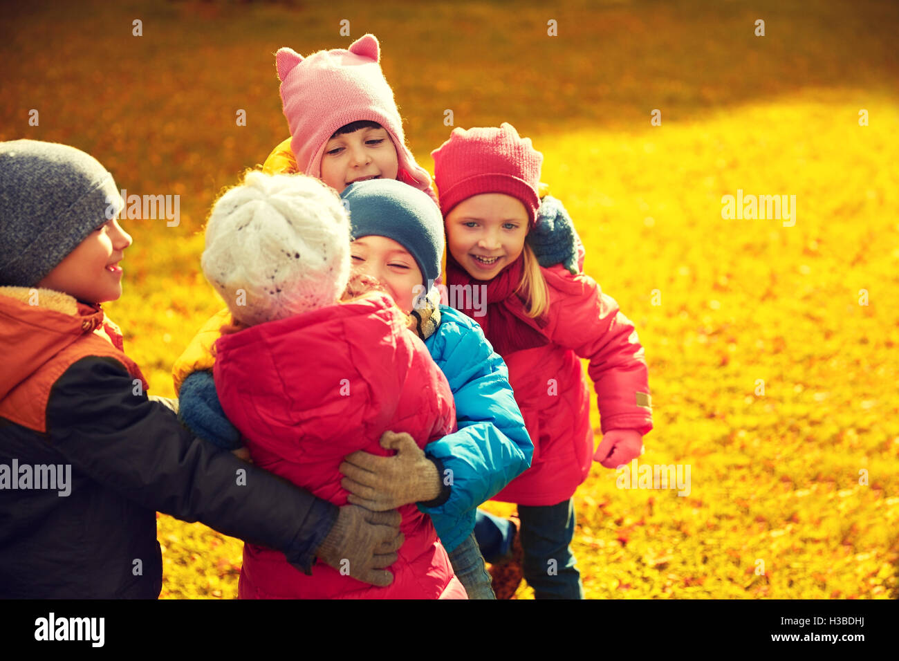 group of happy children hugging in autumn park Stock Photo - Alamy