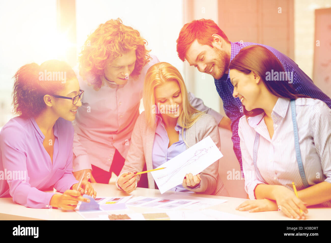 Smiling creative team looking sketch hi-res stock photography and ...