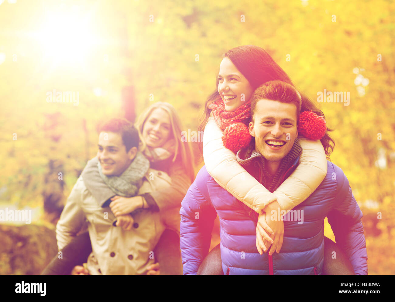 smiling friends having fun in autumn park Stock Photo - Alamy