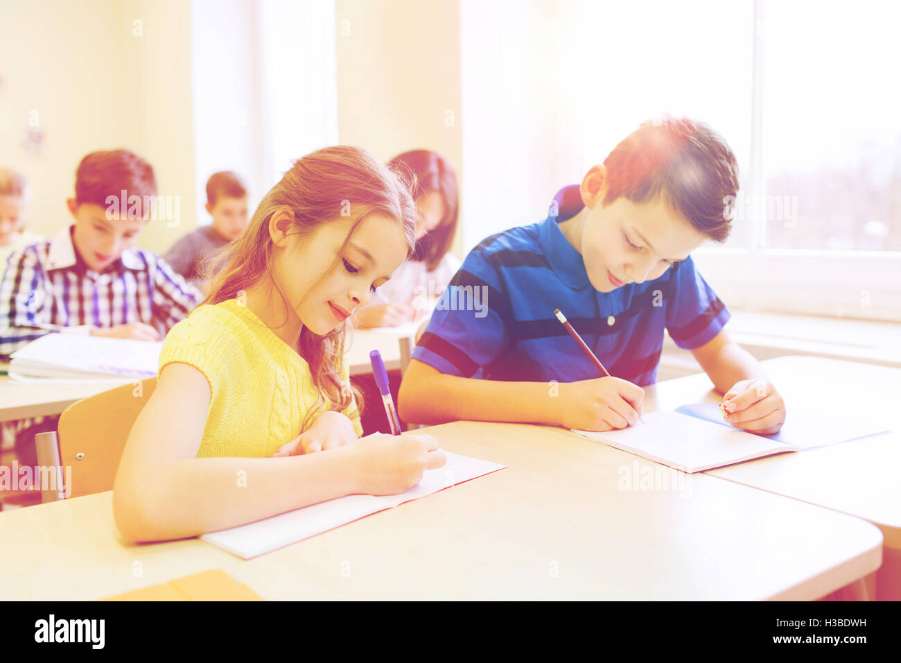 group of school kids writing test in classroom Stock Photo - Alamy