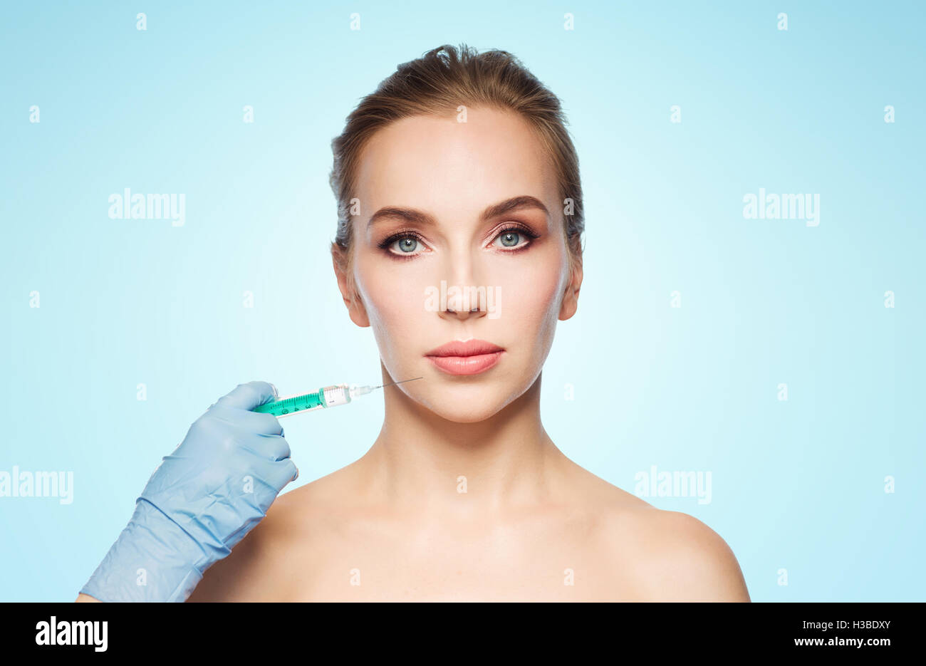woman face and hand with syringe making injection Stock Photo - Alamy