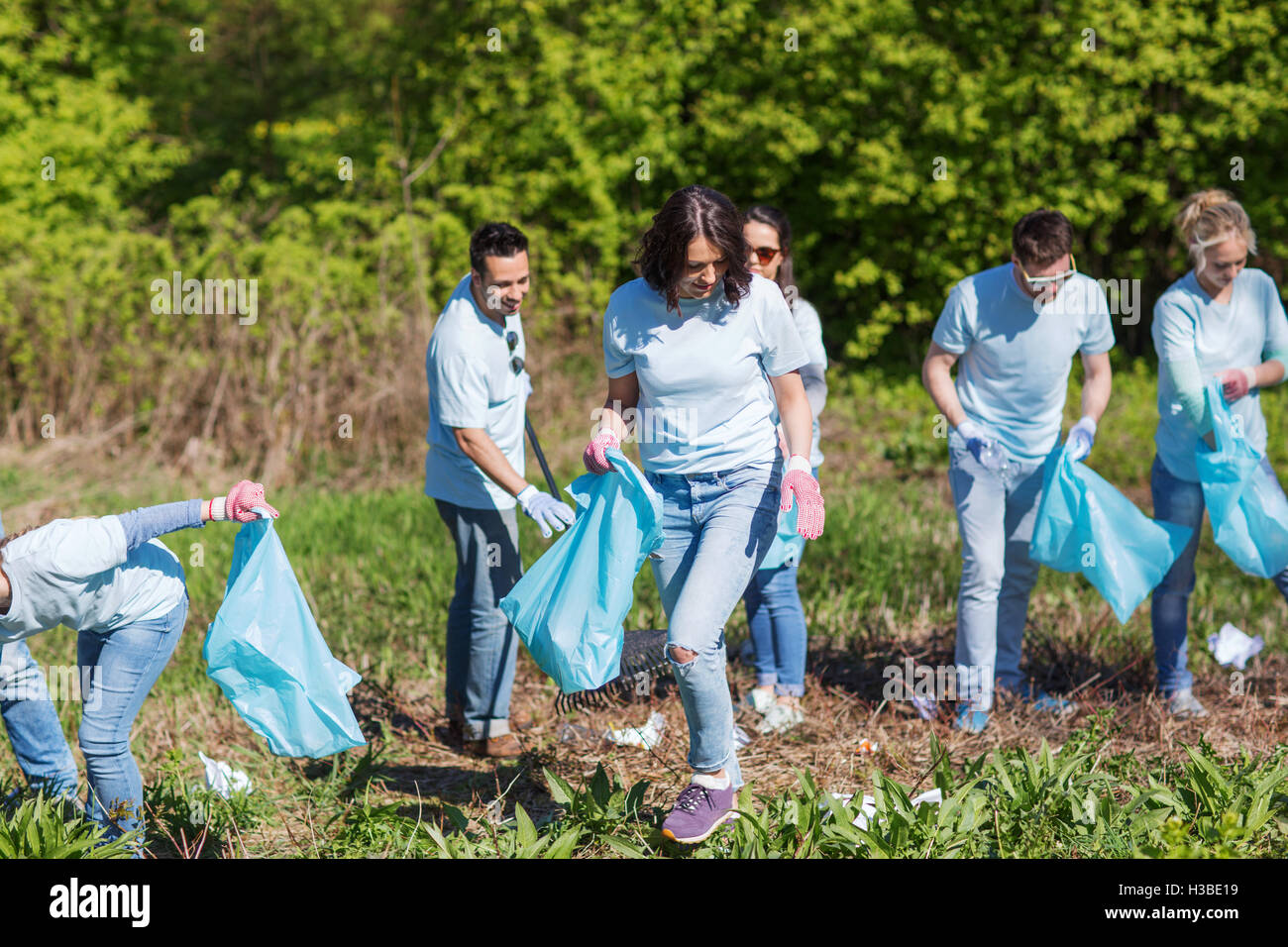 volunteers with garbage bags cleaning park area Stock Photo - Alamy