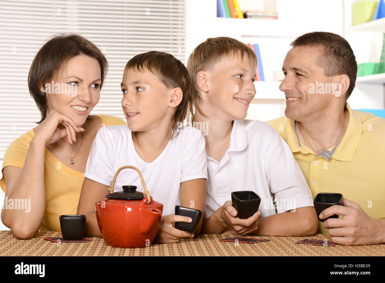 Family drinking tea Stock Photo - Alamy