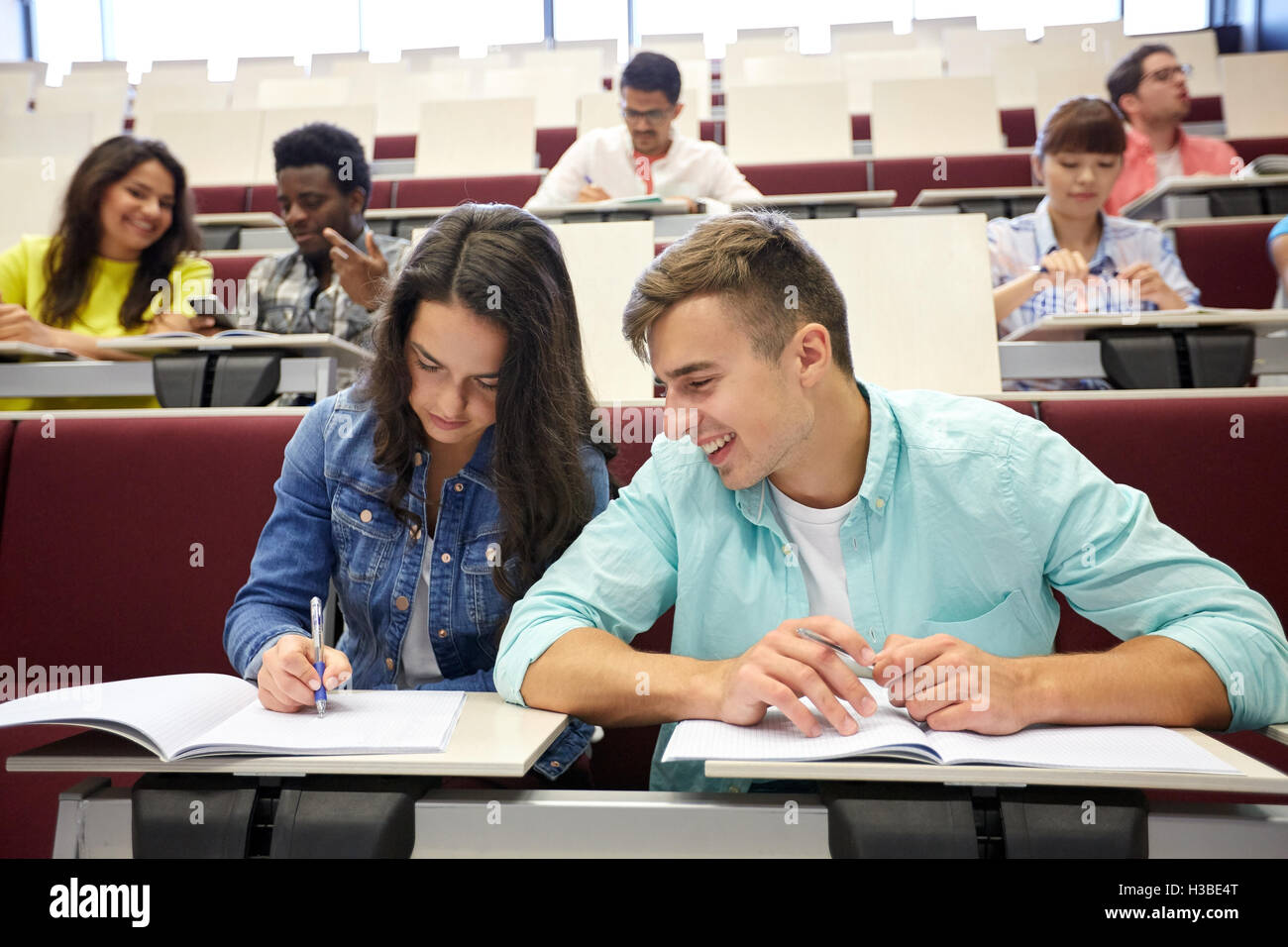 group of students with notebooks at lecture hall Stock Photo - Alamy