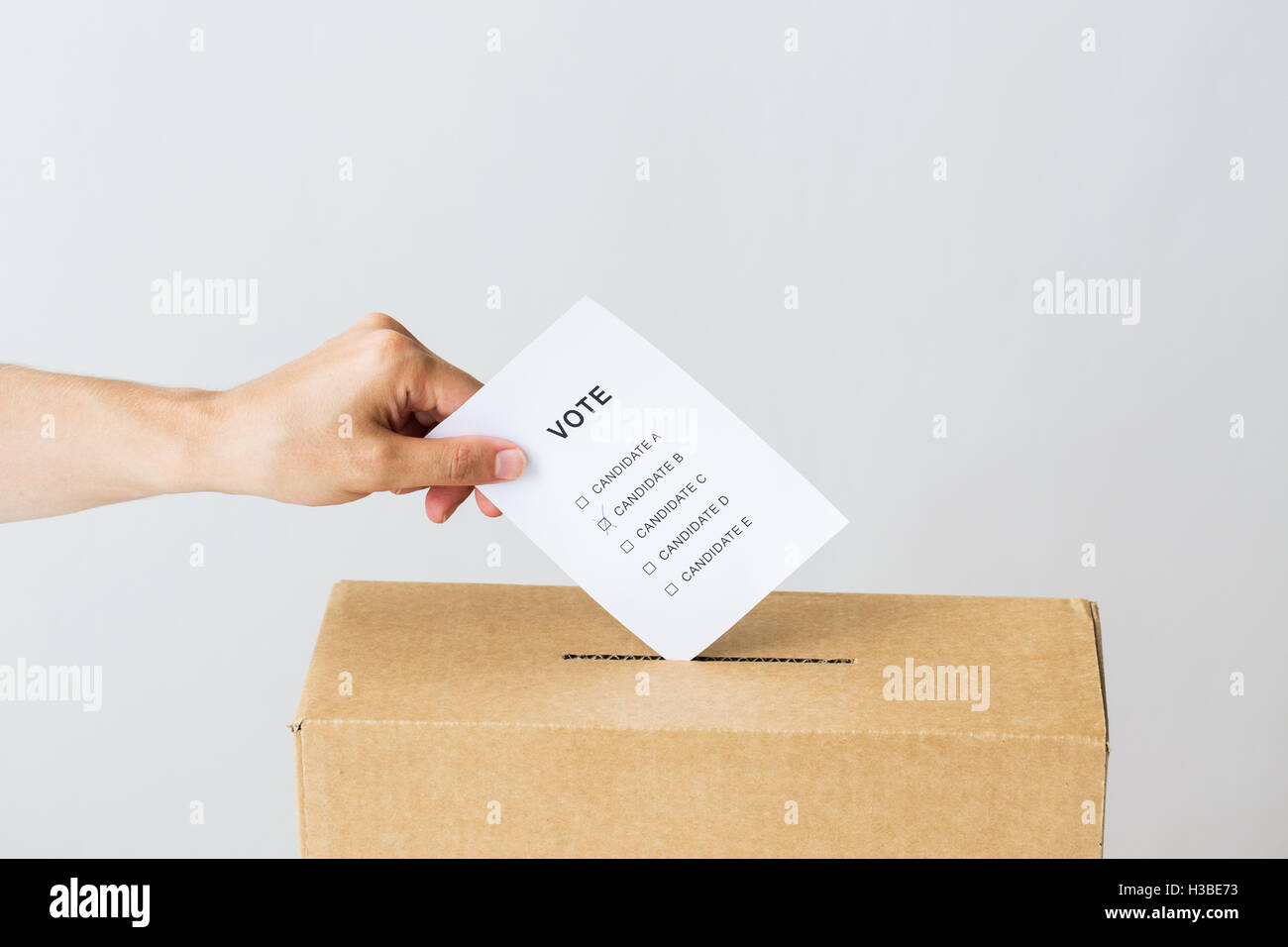 man putting his vote into ballot box on election Stock Photo - Alamy