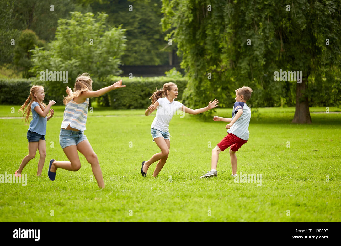 happy kids running and playing game outdoors Stock Photo - Alamy