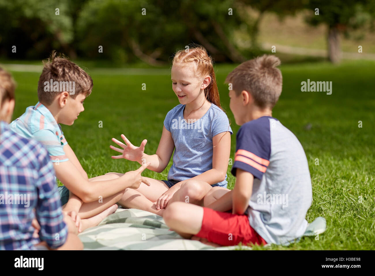 happy kids playing rock-paper-scissors game Stock Photo - Alamy