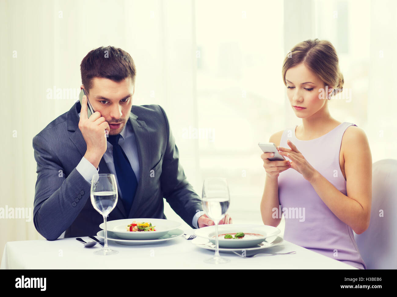 Couple busy with phone dinner table hi-res stock photography and images ...