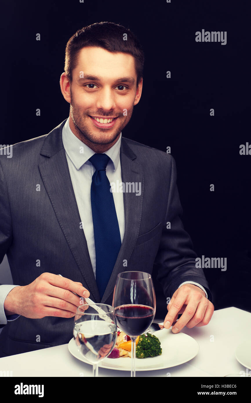 smiling man eating main course Stock Photo - Alamy