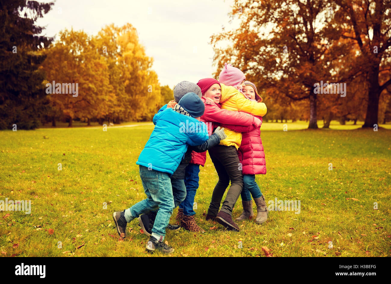 group of happy children hugging in autumn park Stock Photo - Alamy