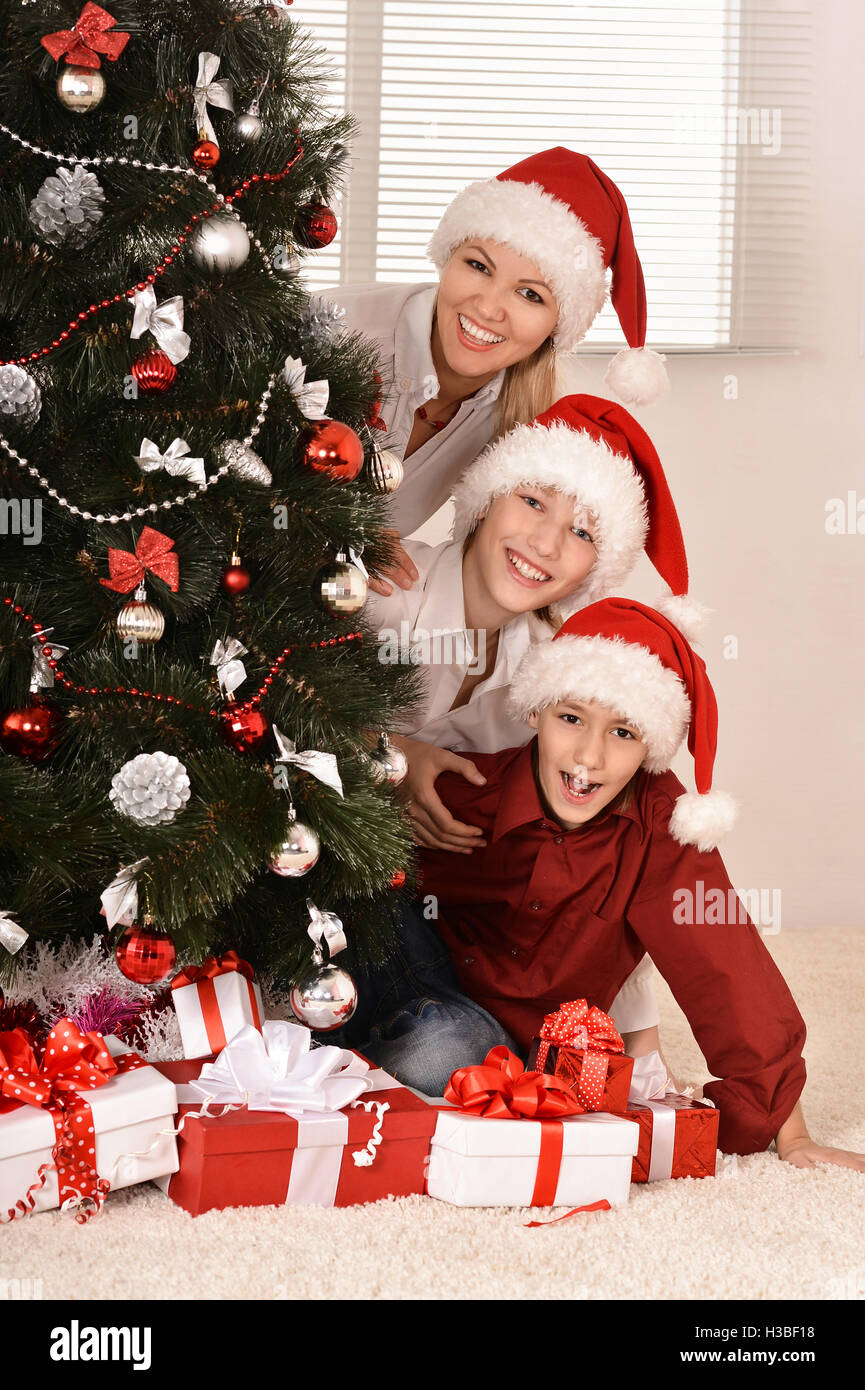 Mom and children in santa hats Stock Photo - Alamy